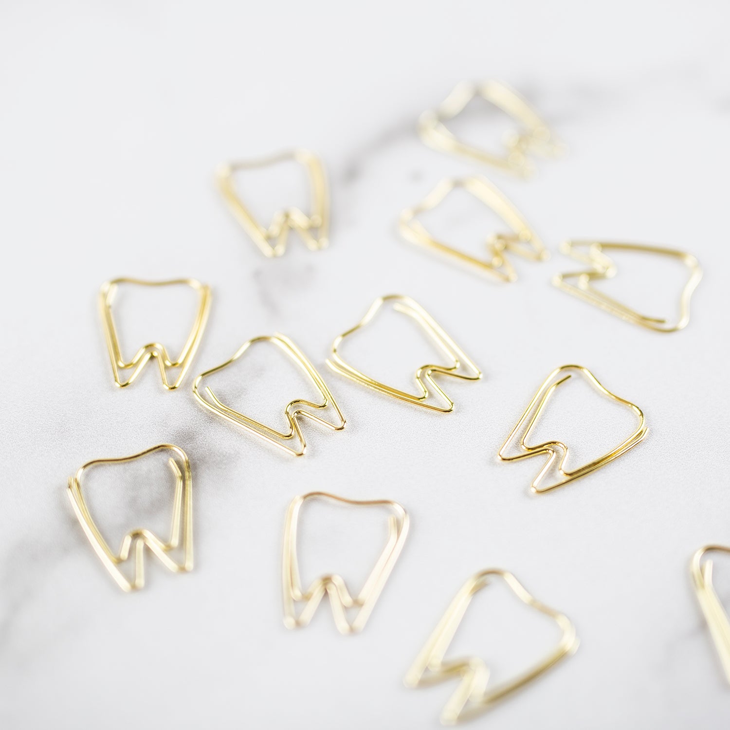 Gold tooth-shaped paper clips – Lilac Paper